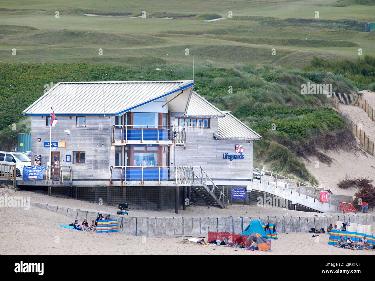 The RNLI lifeguards building, with a golf course behind it, at Fistral ...