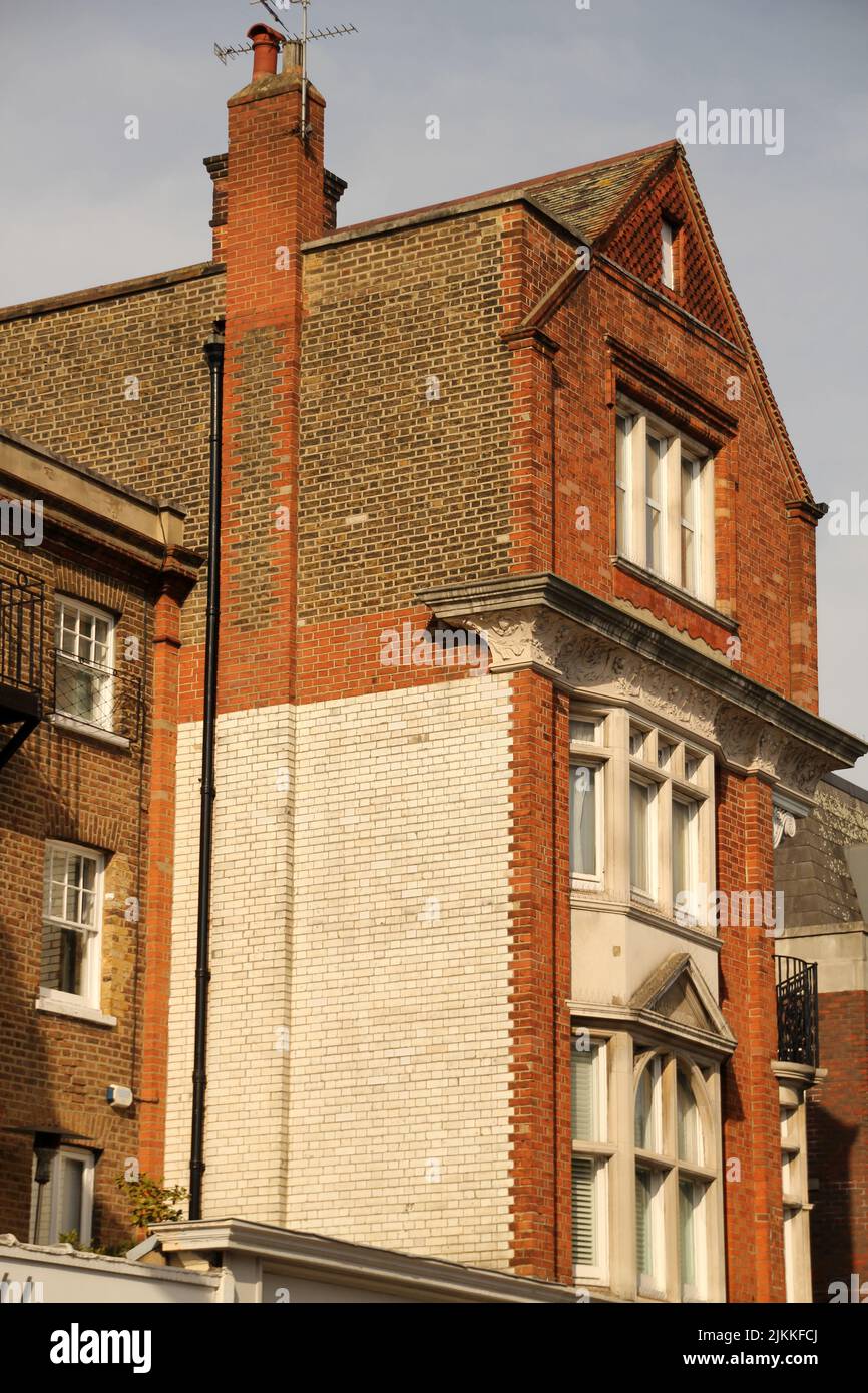 A beautiful view of an old apartment building with small windows in the ...