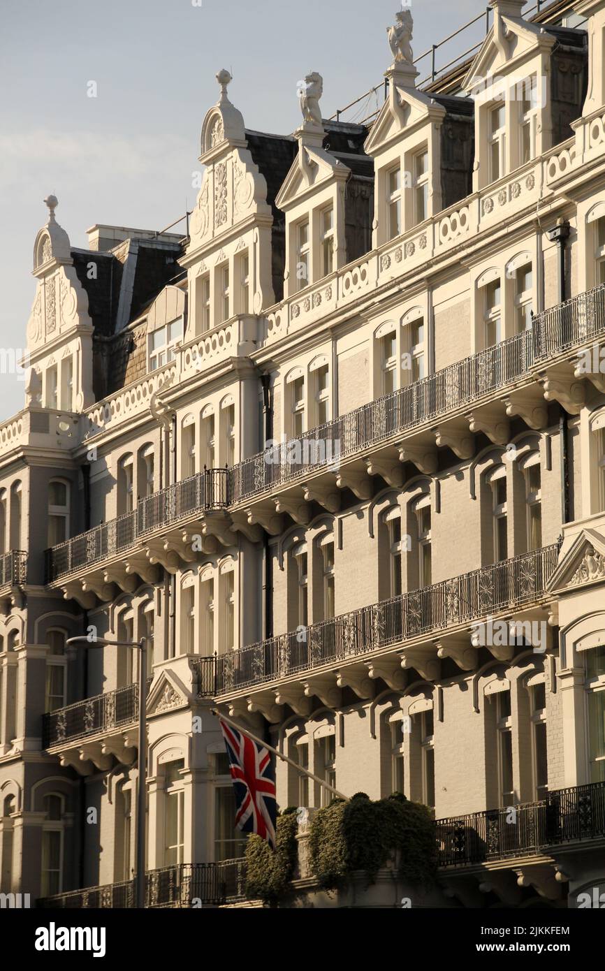 A beautiful view of an old white building with the flag of Great ...