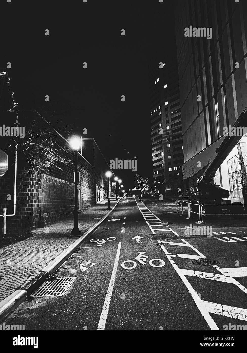 A vertical shot of road markings and arrow signs on asphalt Stock Photo ...