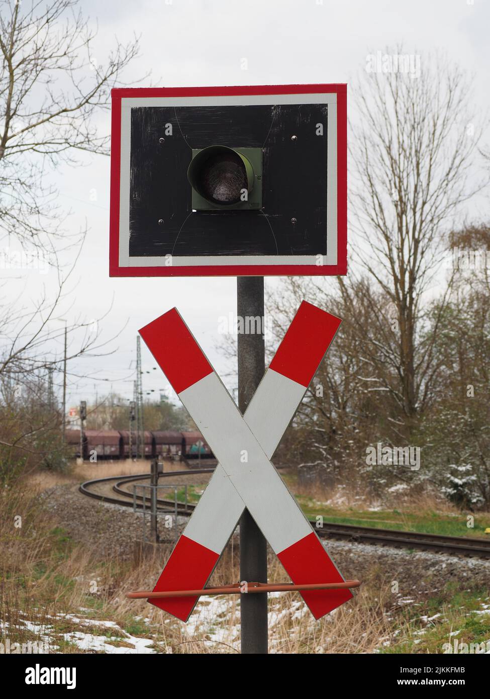 A vertical shot of a sign for not crossing the rails when a train comes ...