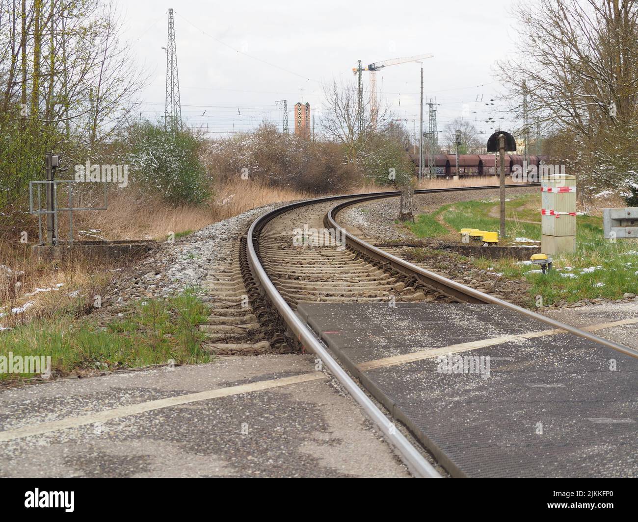 An empty railroad with curving train tracks surrounded by trees Stock ...