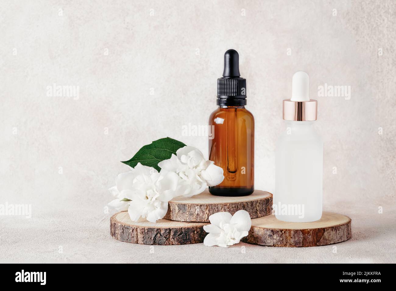 Two glass dropper bottles for medical and cosmetic use and jasmine ...