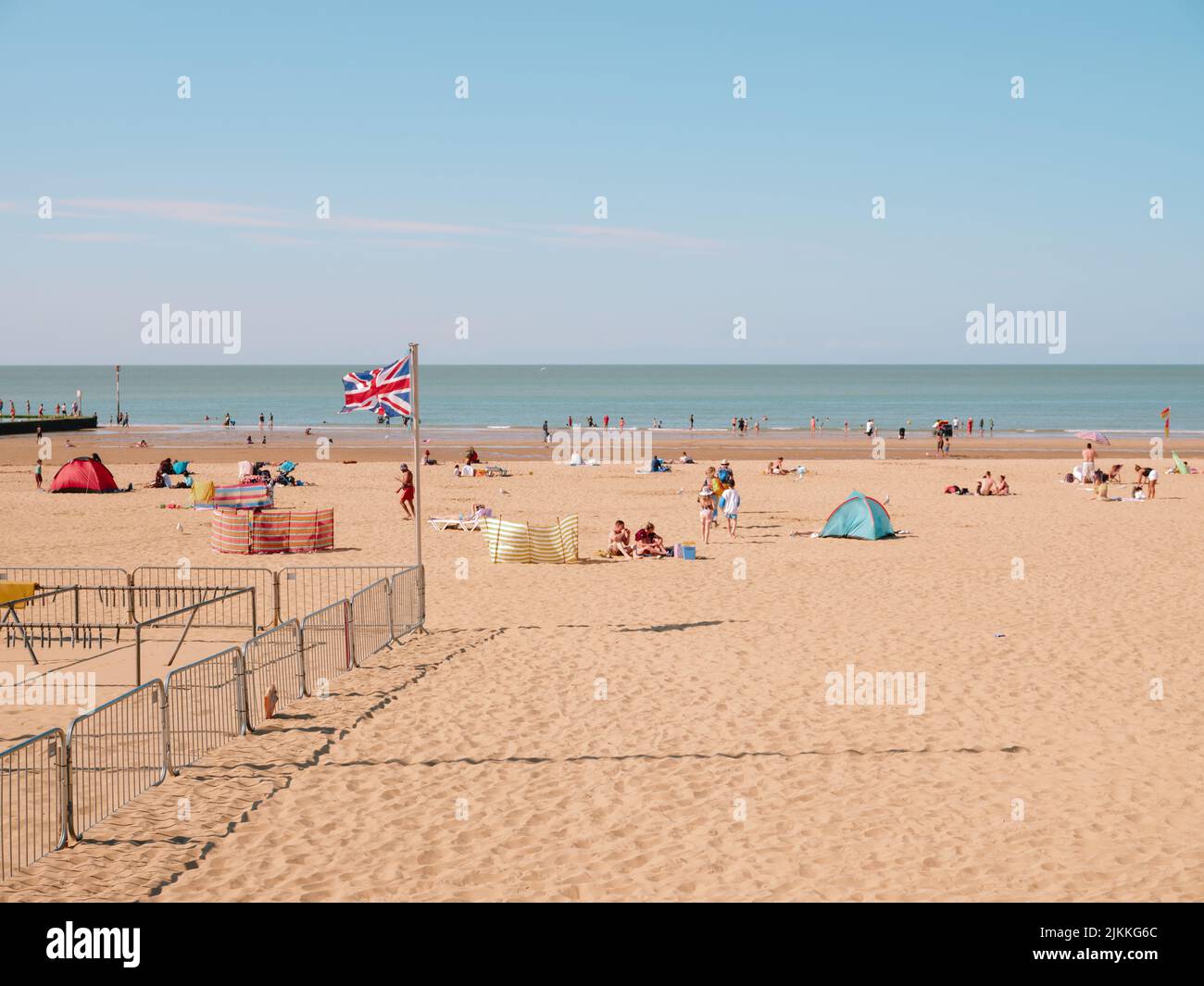 Sunbathing visiting tourists on the sandy Margate beach Kent England UK ...