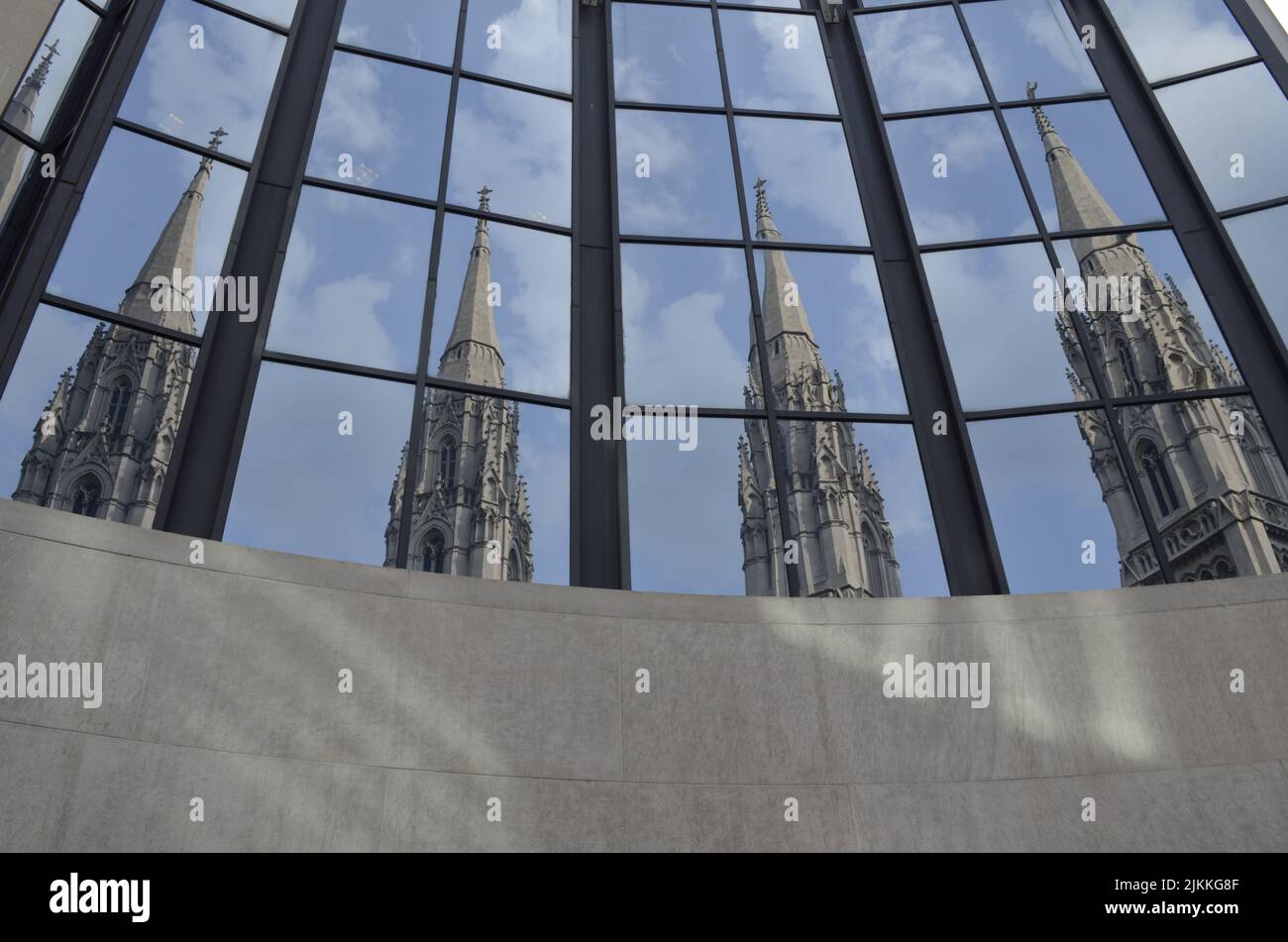 A scenic shot of the reflection of tower buildings on glass windows ...