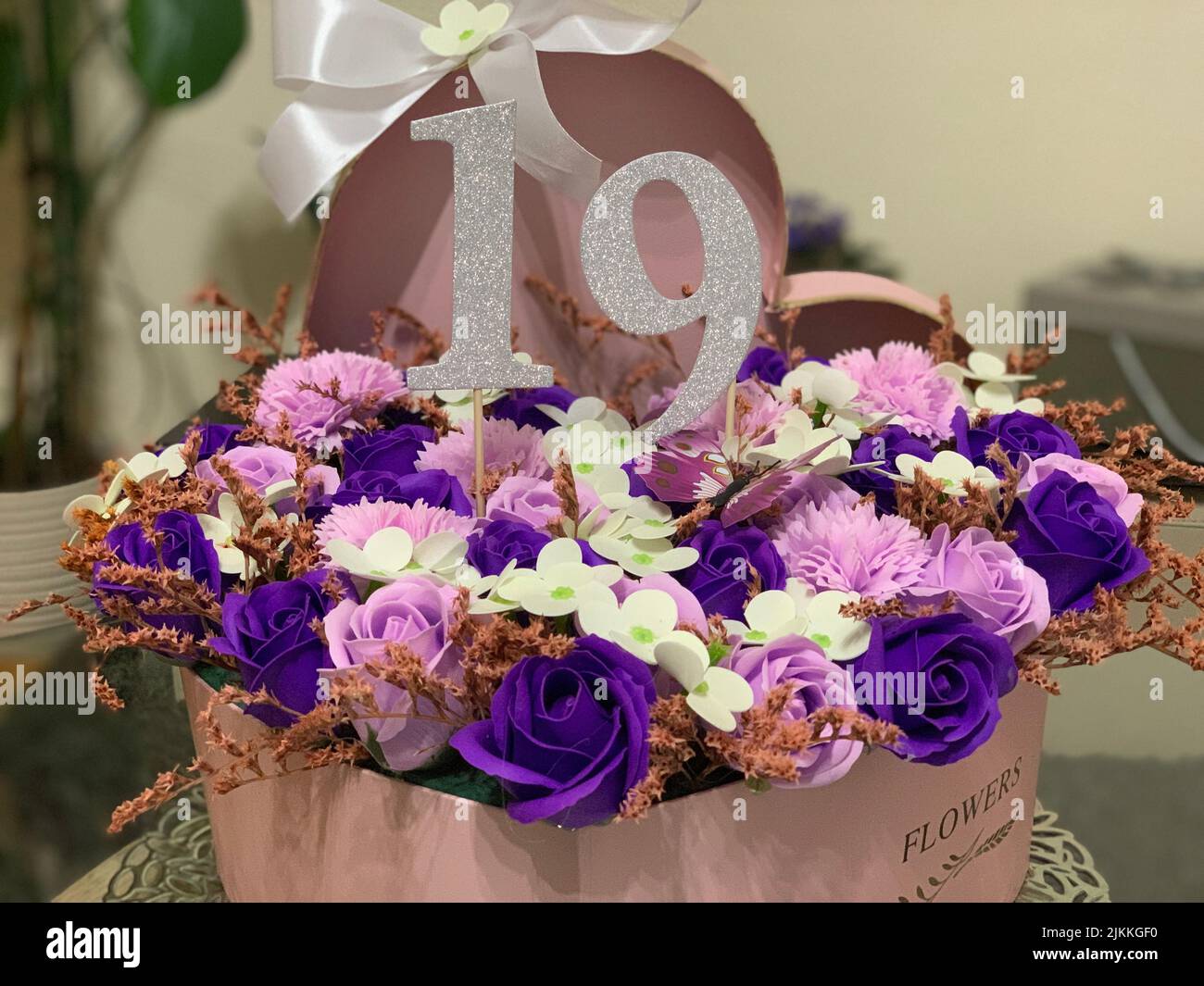 A birthday bouquet with purple flowers and number 19 Stock Photo - Alamy
