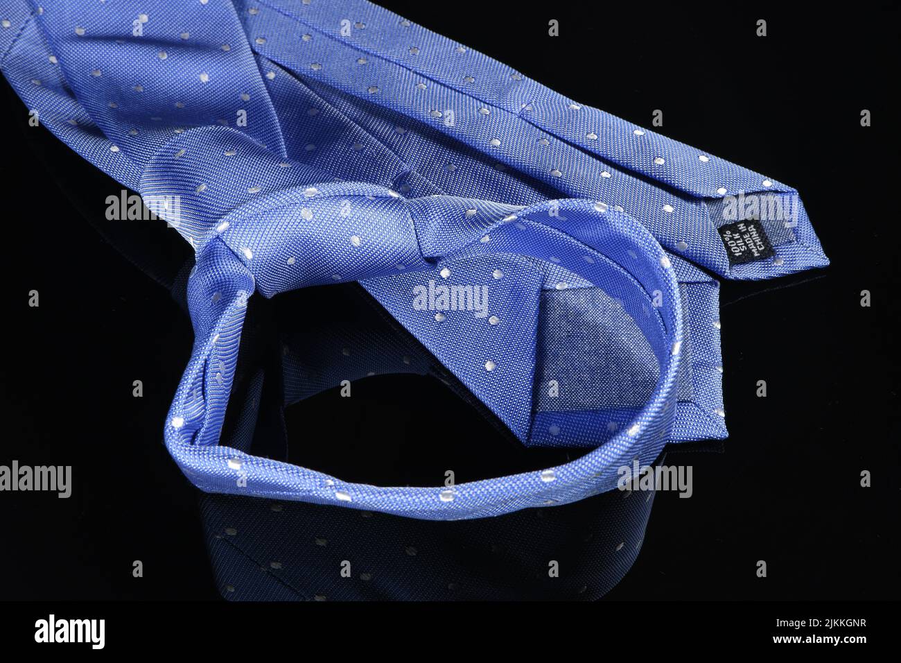 A polyester designed necktie with tie knot on black background Stock ...