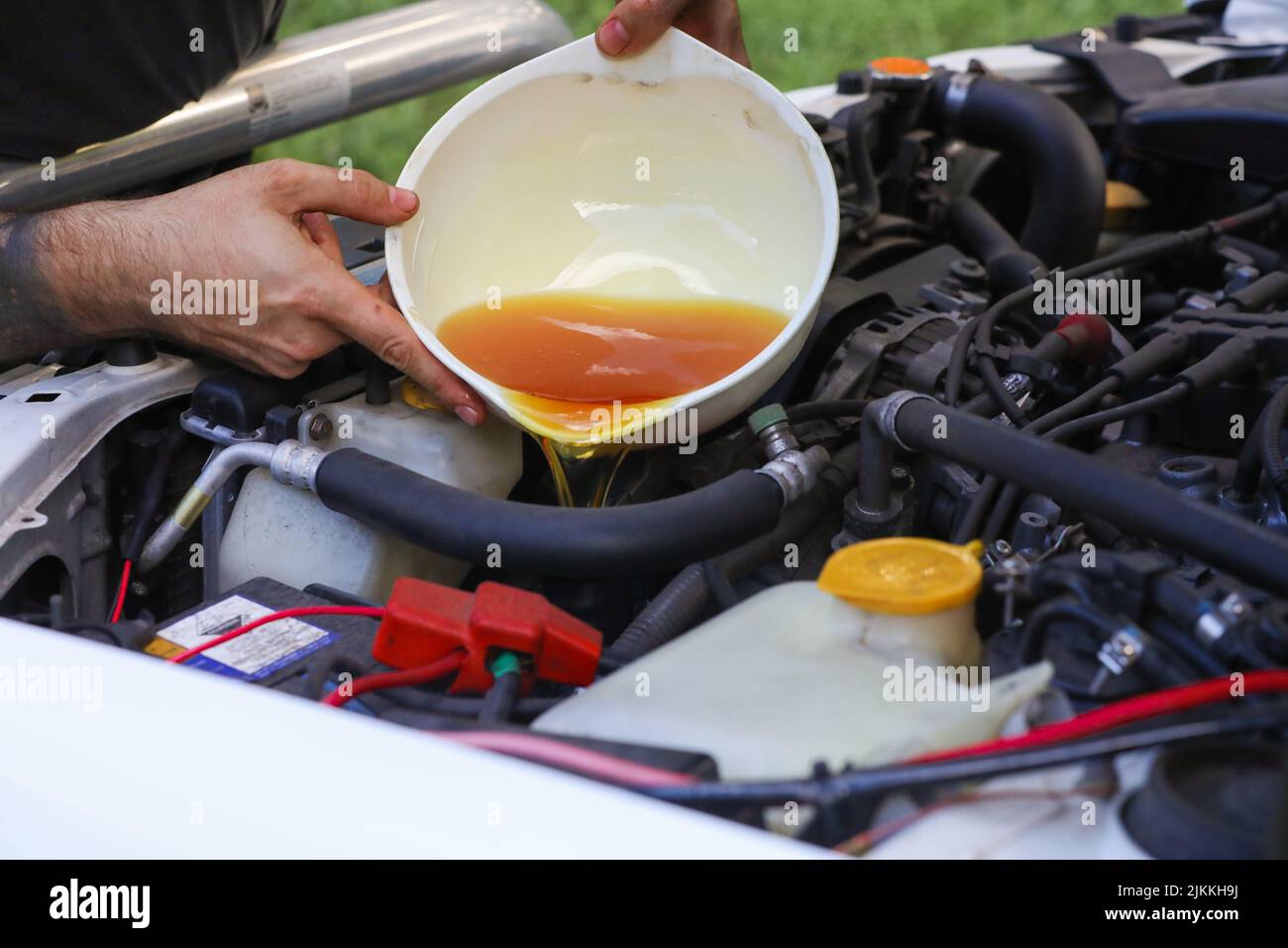 A close-up shot of a person changing car oil Stock Photo - Alamy