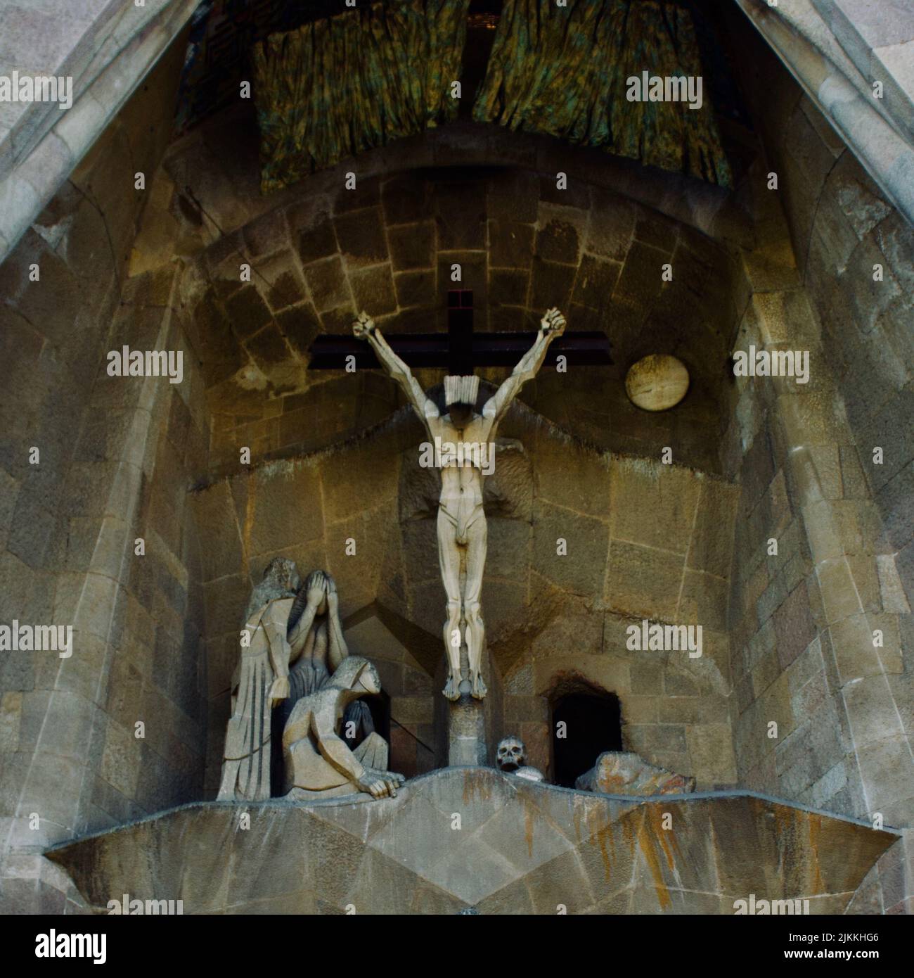The statue of the crucified Jesus Christ on the facade of the Sagrada Familia Cathedral ...