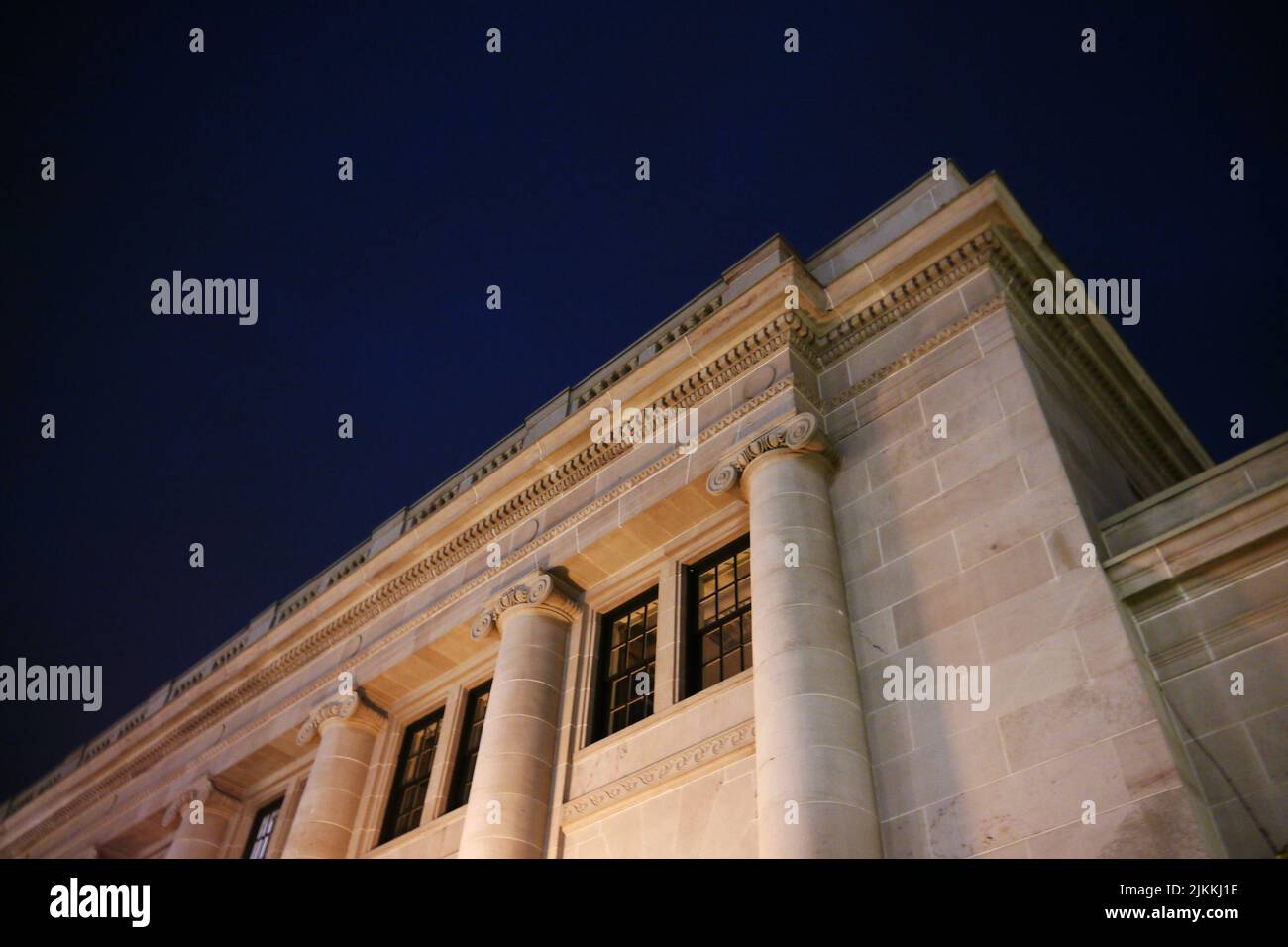 A low angle shot of a beautiful stone building under the dark clear sky ...