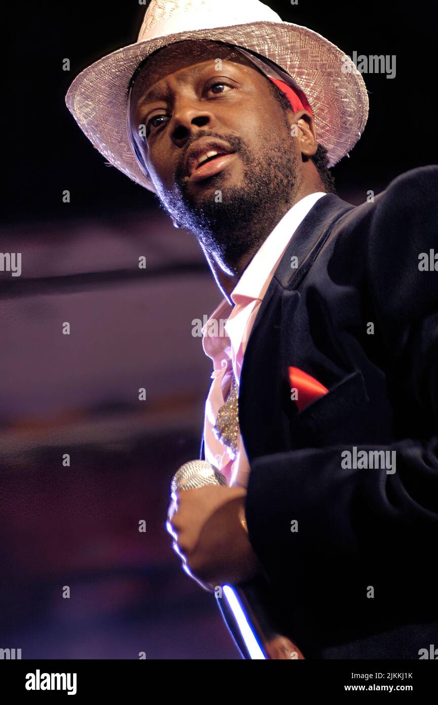 A vertical shot of singer Wyclef Jean performing live with the band The ...