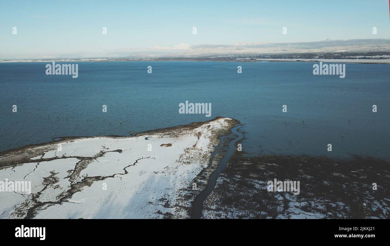 An aerial view of the beautiful ocean with greenery around it covered ...