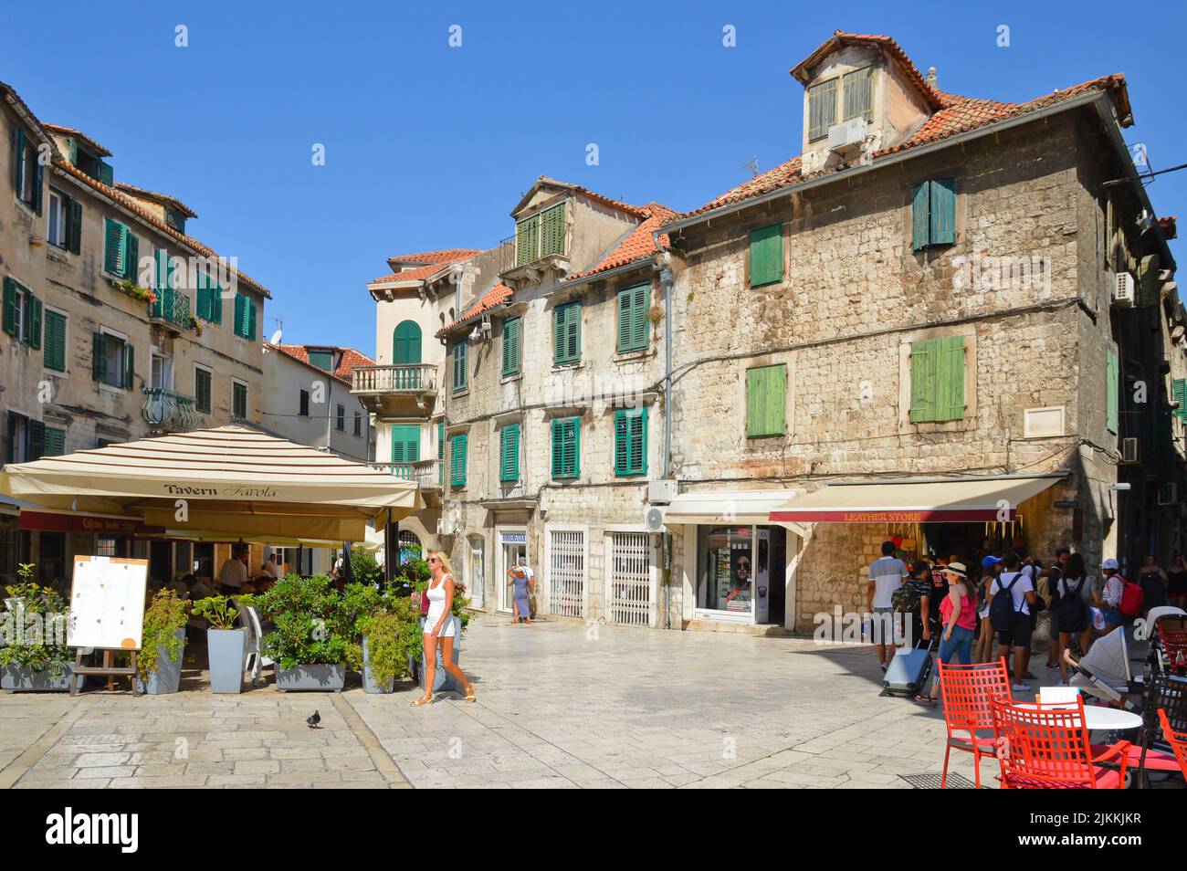 A group of people in a busy square in the historic center of Split ...