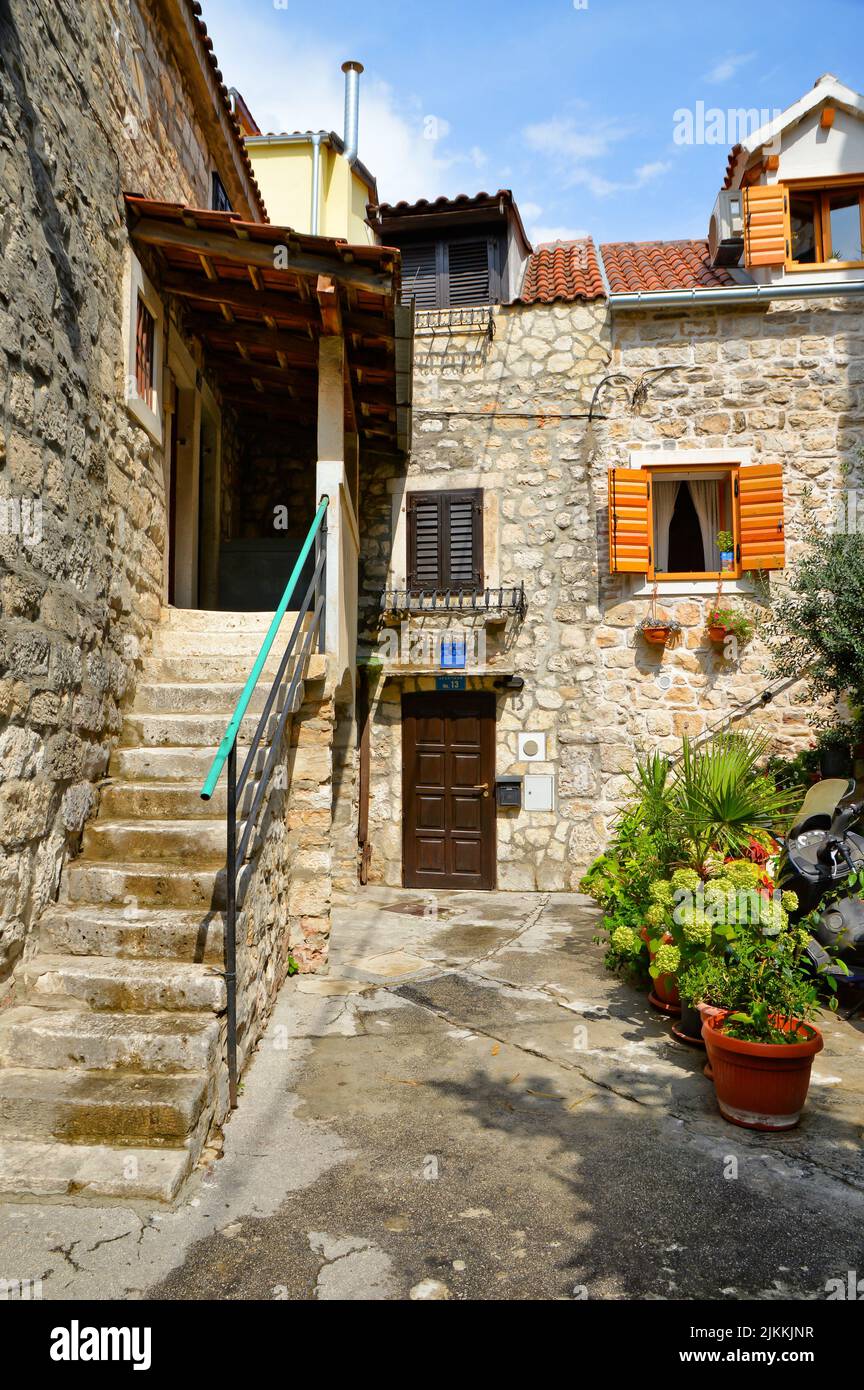 A vertical shot of a cute stone houses with a staircase and outdoor ...