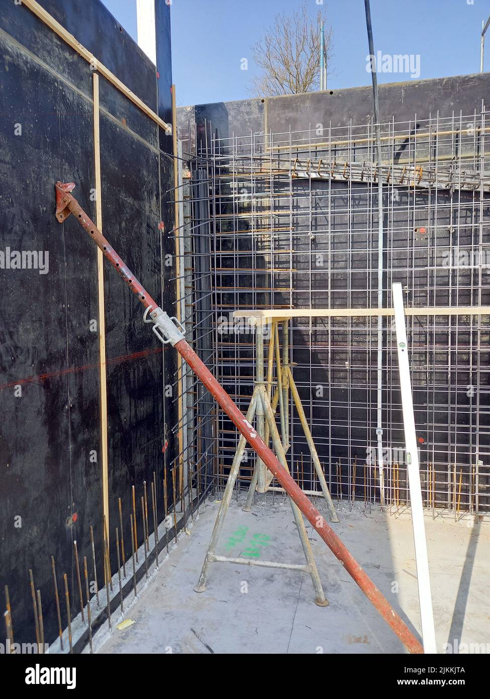 A vertical shot of a concrete reinforcement steel shuttering wall in a ...