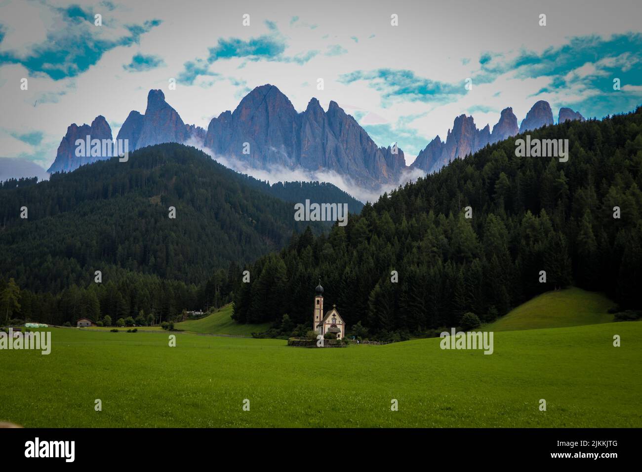 a Landscapes with San Giovanni Church and small village in Val di Funes ...