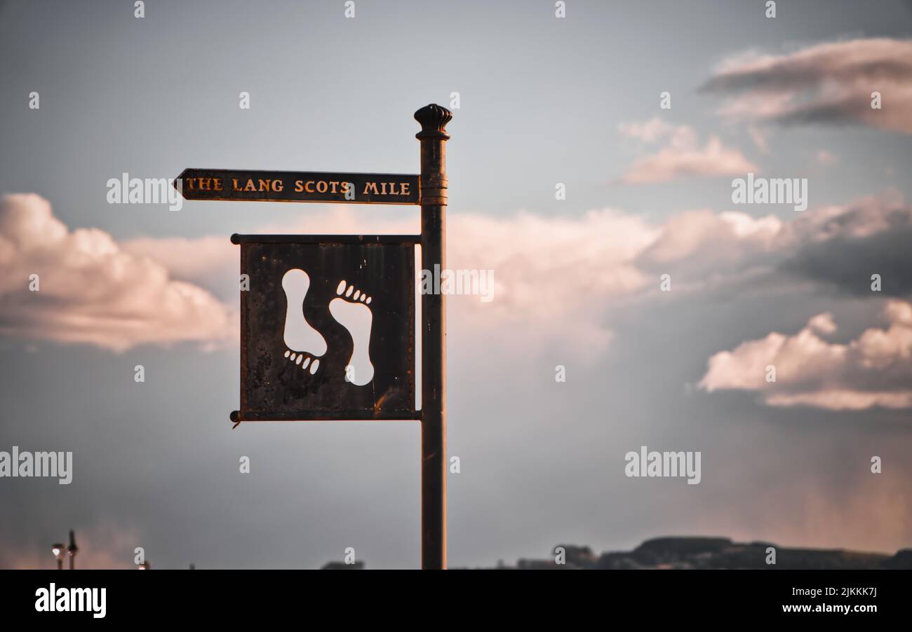 A metal sign showing the direction to Lang Scots Mile beach in Ayr ...