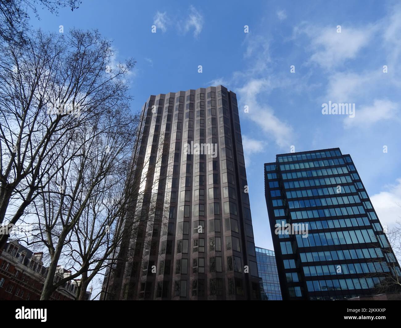 A low angle view of the grey and blue skyscrapers of the London Skyline ...