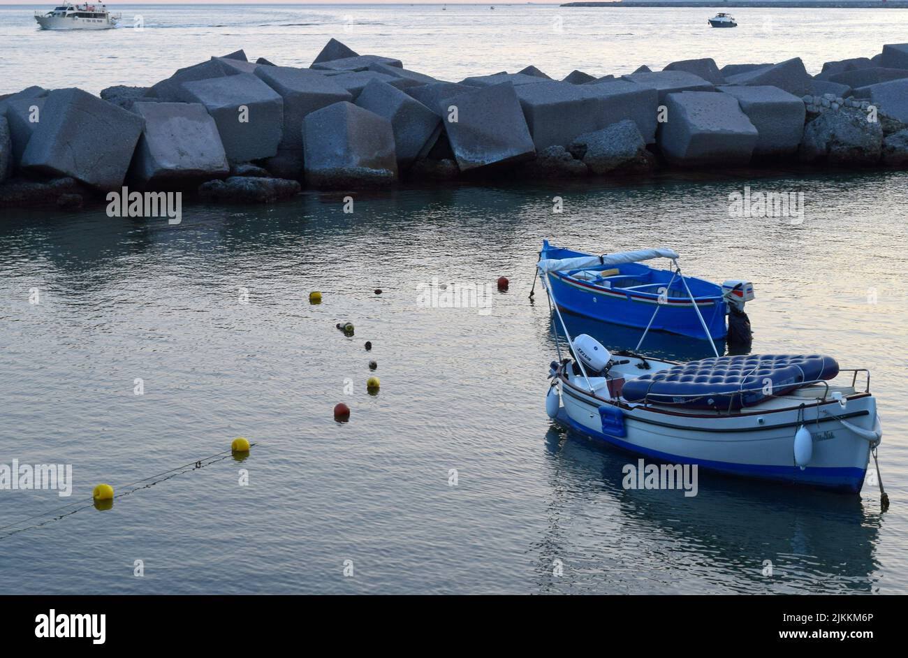 A view of two blue and white boats gliding on the calm water Stock ...