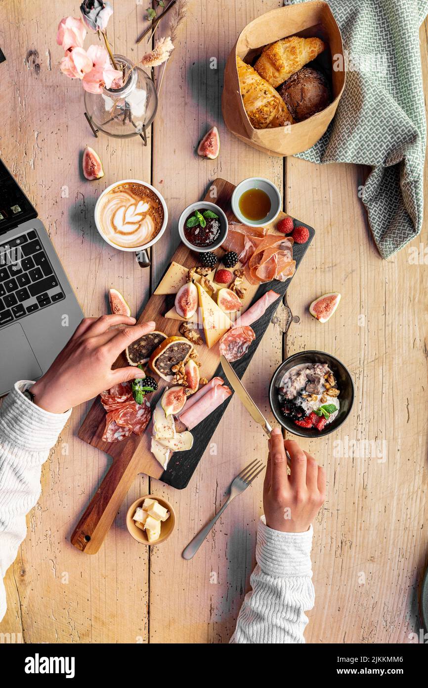 A vertical closeup of the wooden table with various types of food Stock ...