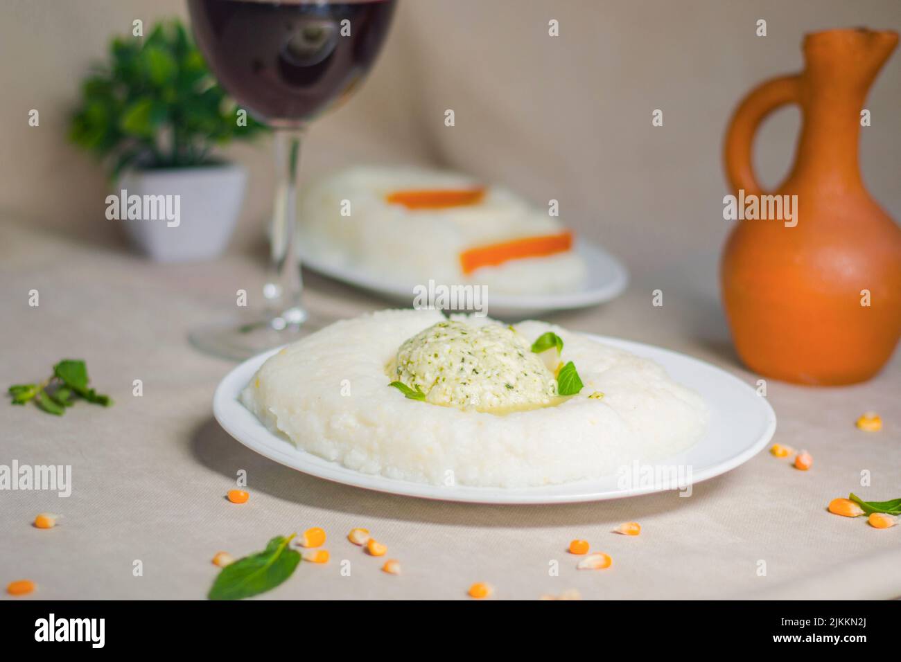 Georgian traditional food and cuisine ghomi with cheese and red wine ...