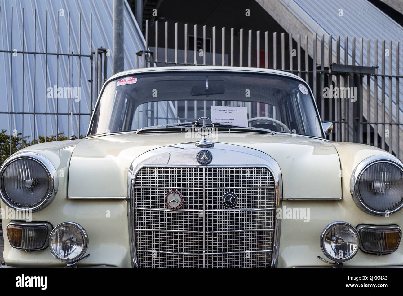 A beige Mercedes-Benz W110 200D car, displayed at a classic car ...