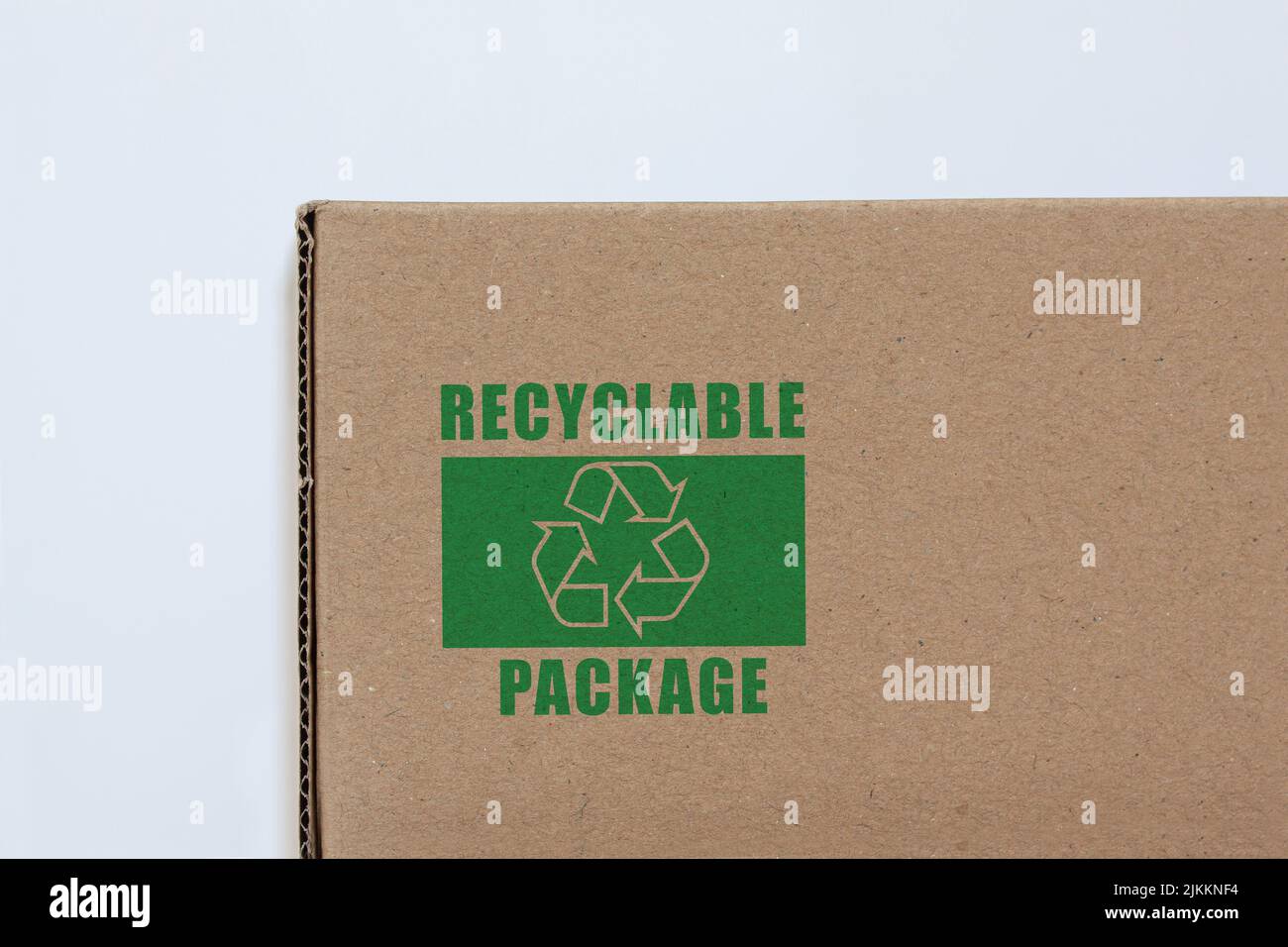 Cardboard pakage with printed recycling symbol. Photo with while ...
