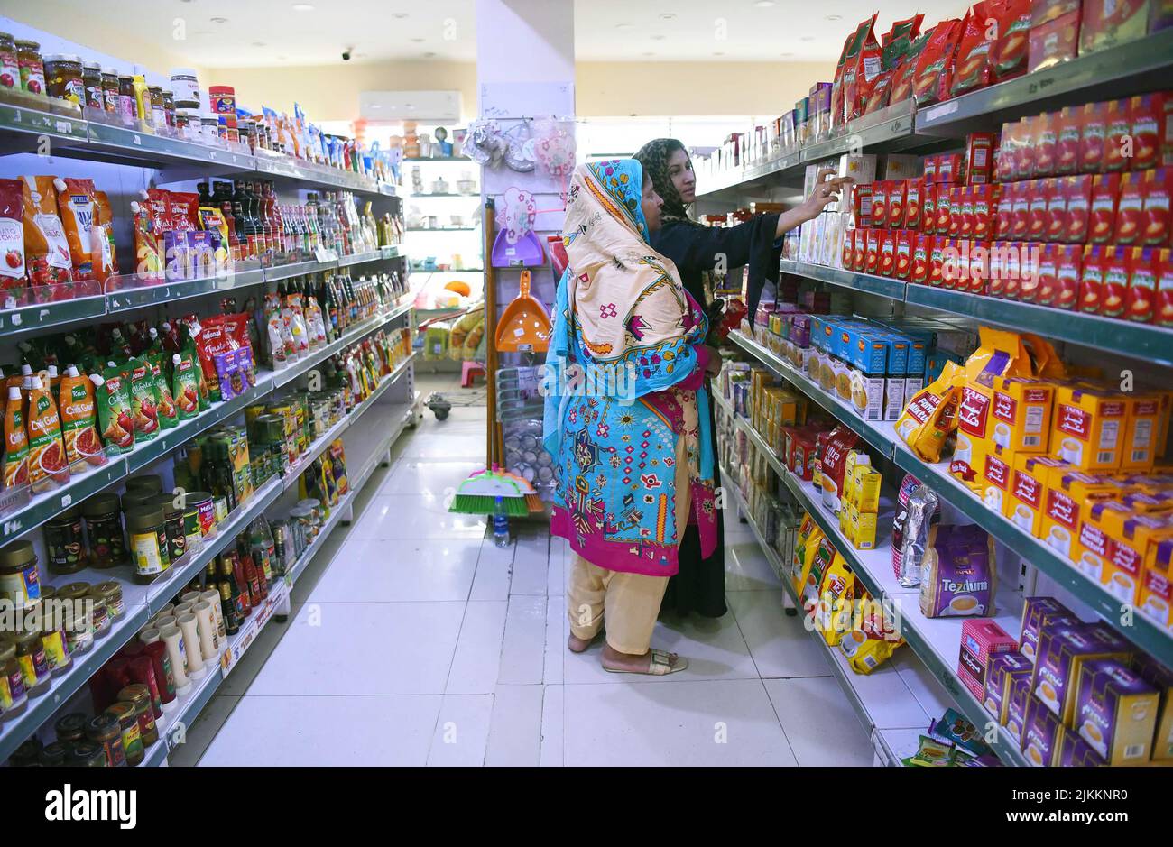 Karachi. 2nd Aug, 2022. People shop at a grocery store in southern ...