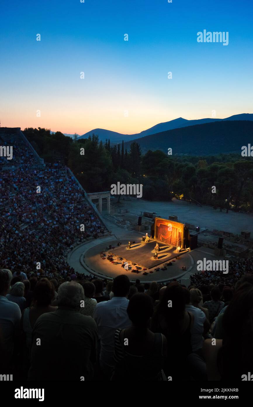 A vertical shot of crowd sitting at the ancient theatre of Epidaurus ...