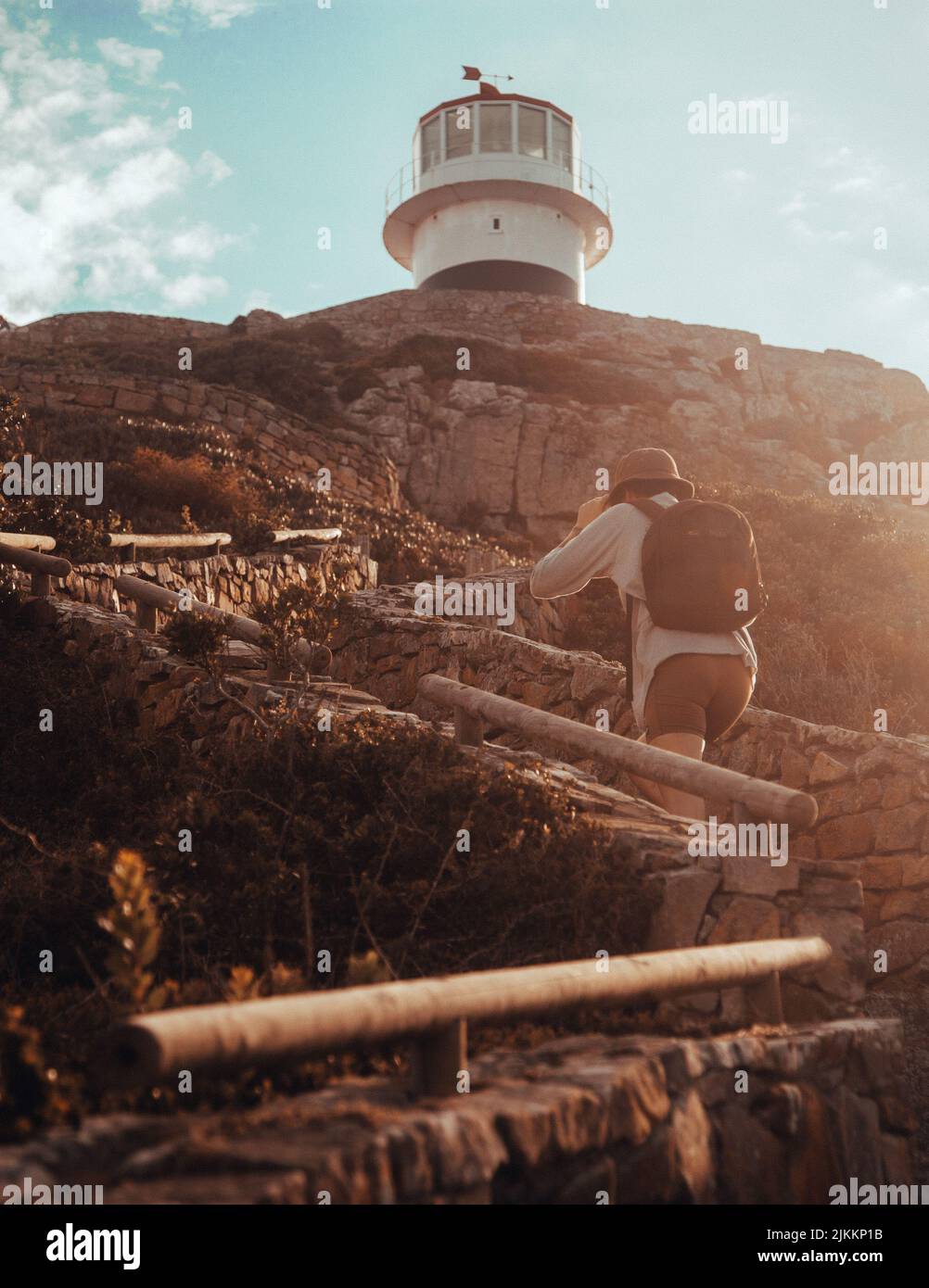 Man climbing up to the Old Cape Point Lighthouse Stock Photo - Alamy