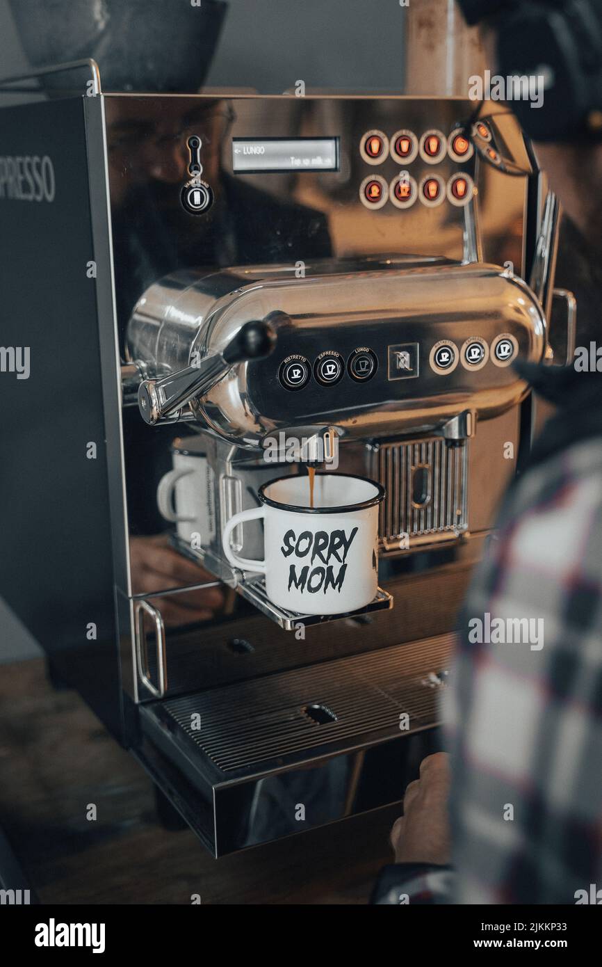 A white cup under the coffee machine Stock Photo - Alamy