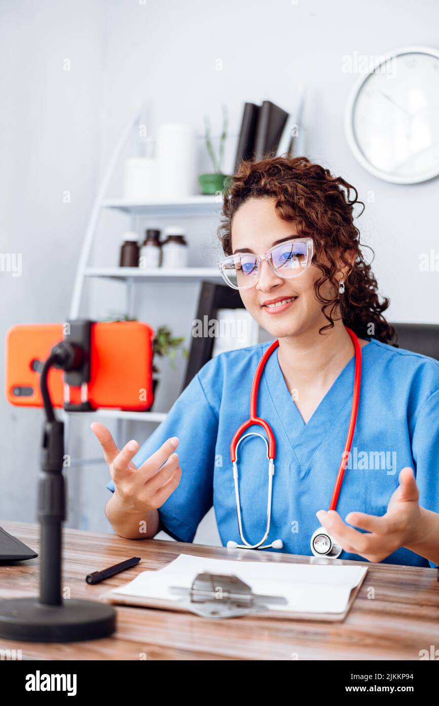 influencer female doctor using her phone making a video, social media ...