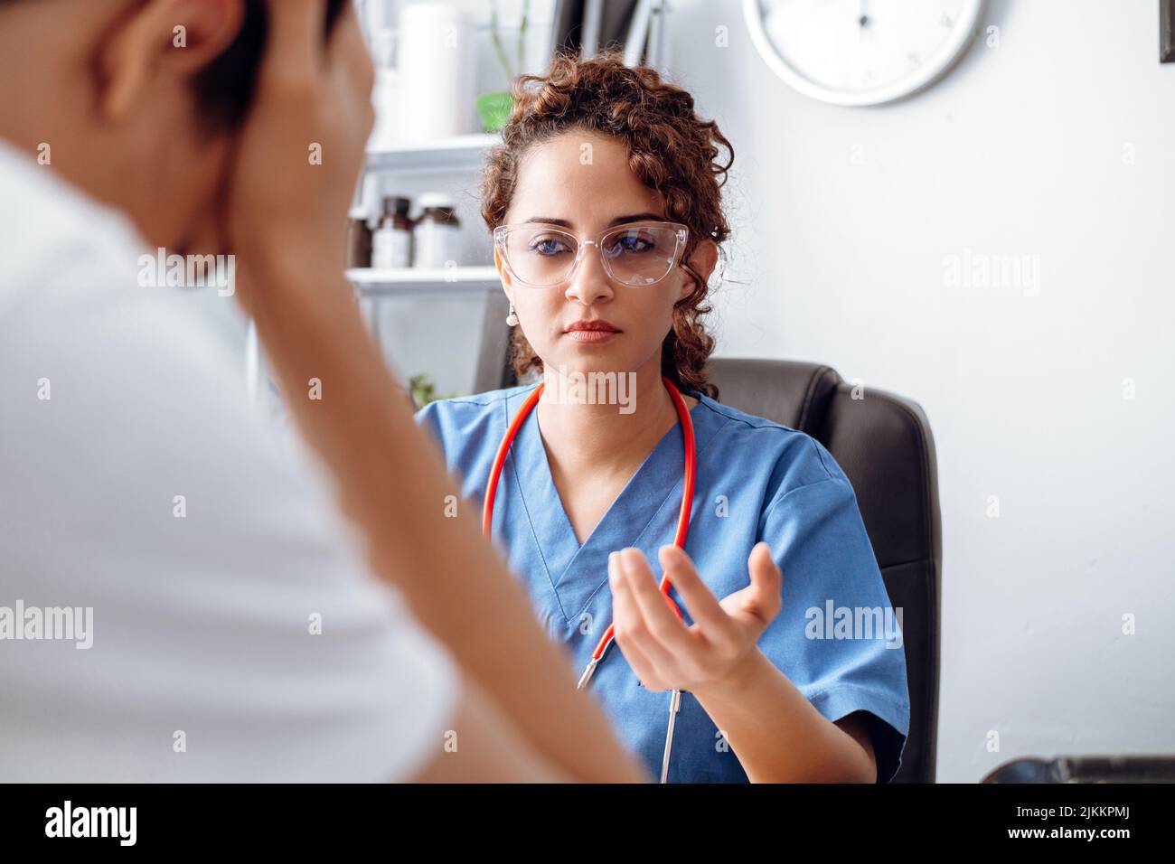 Female doctor doing an exam consultation with a sad patience Stock ...