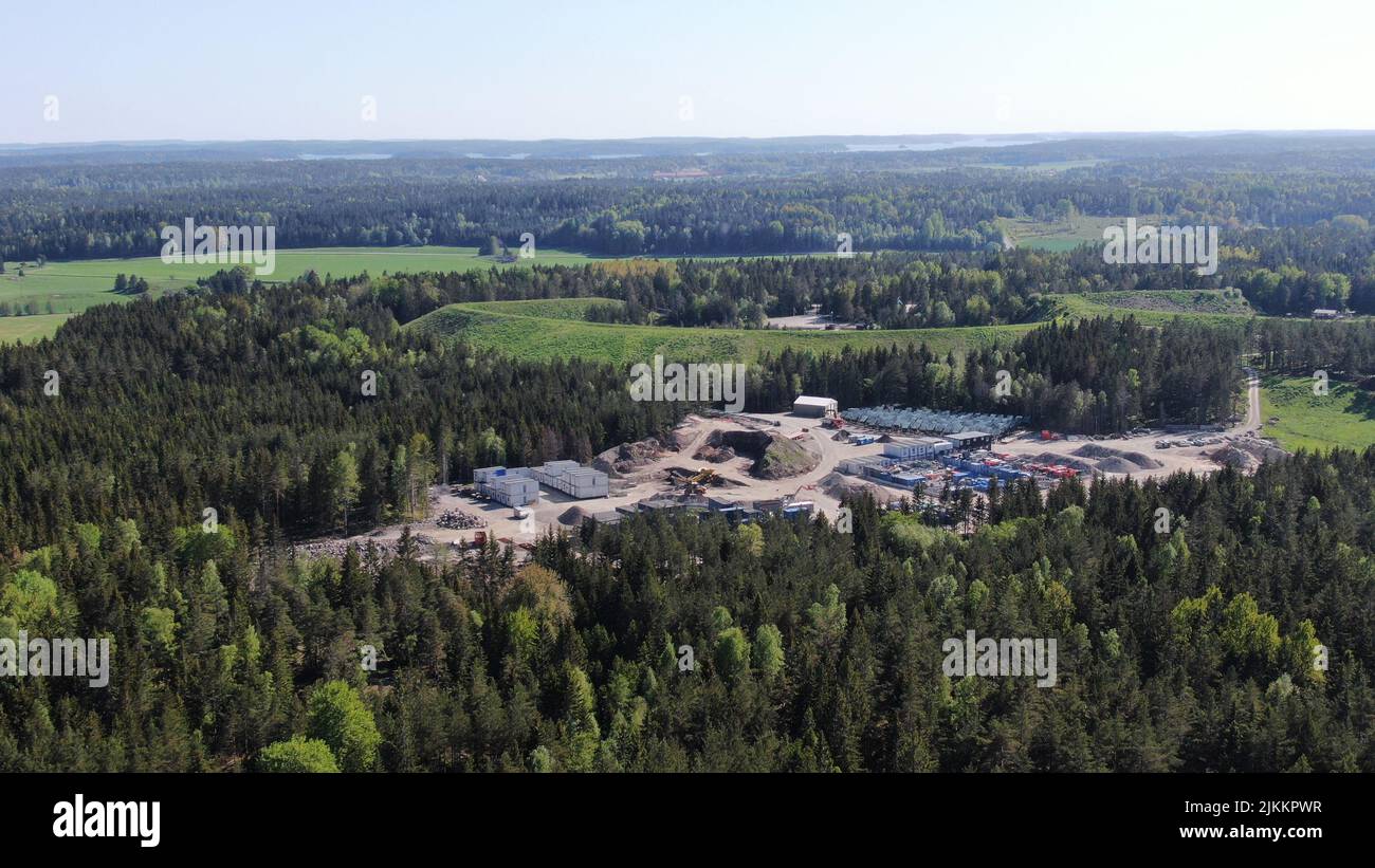 An aerial view of a construction area in the middle of a lush forest ...