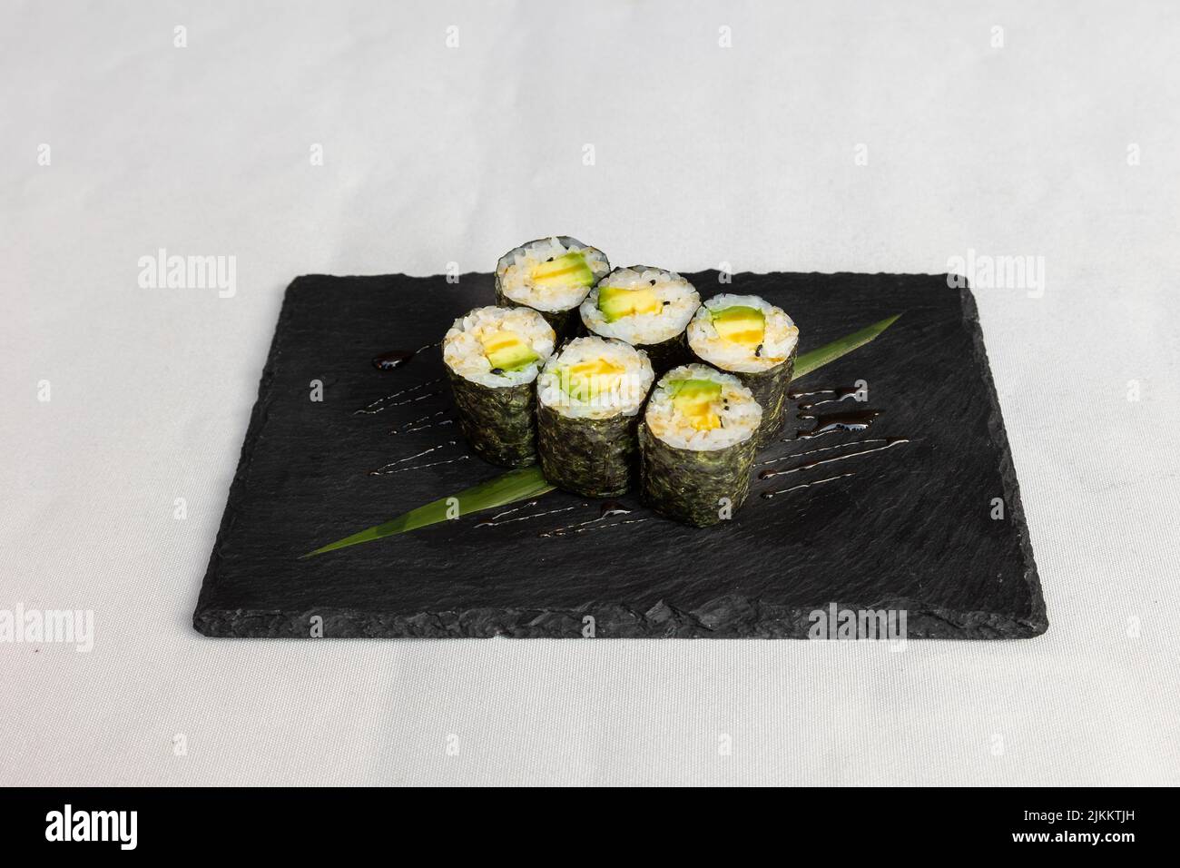 A Top view of sushi set on a black plate on a white background Stock ...