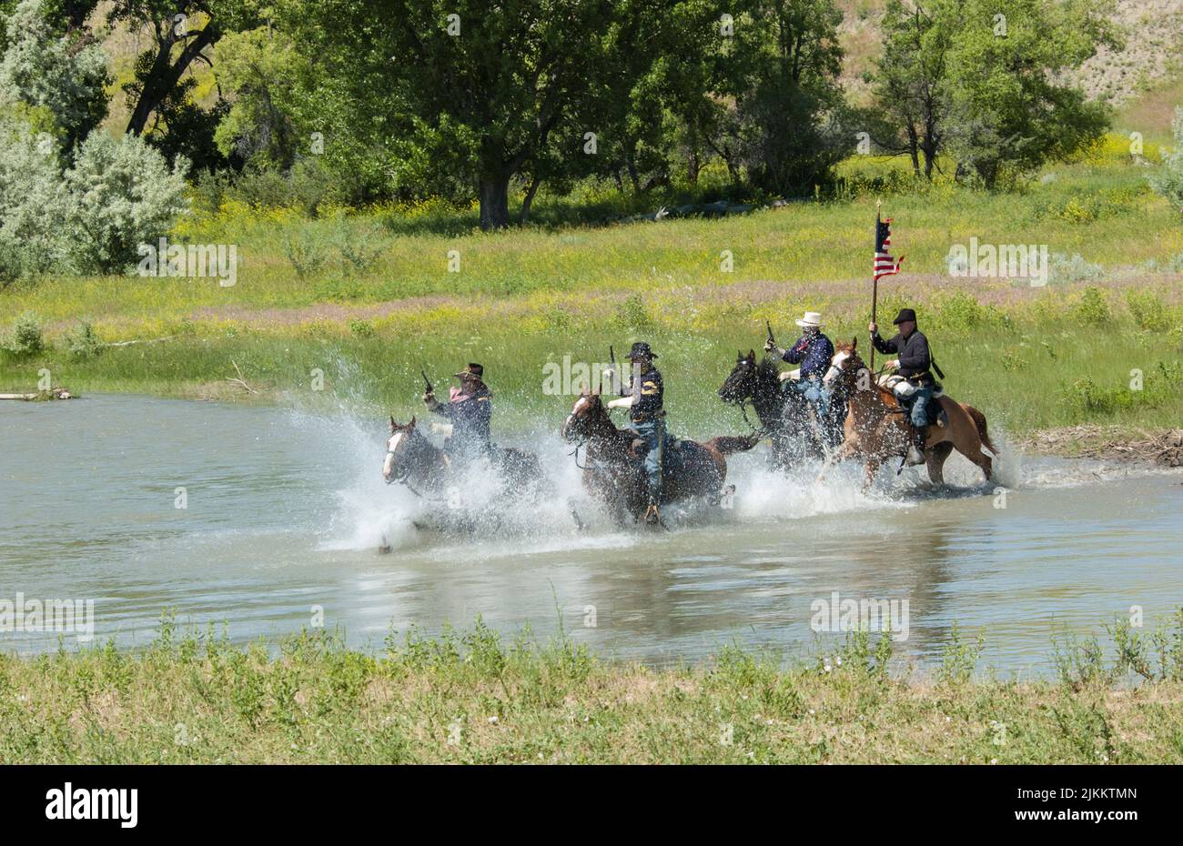 US soldiers dressed in cavalry uniforms on horseback crossing the ...