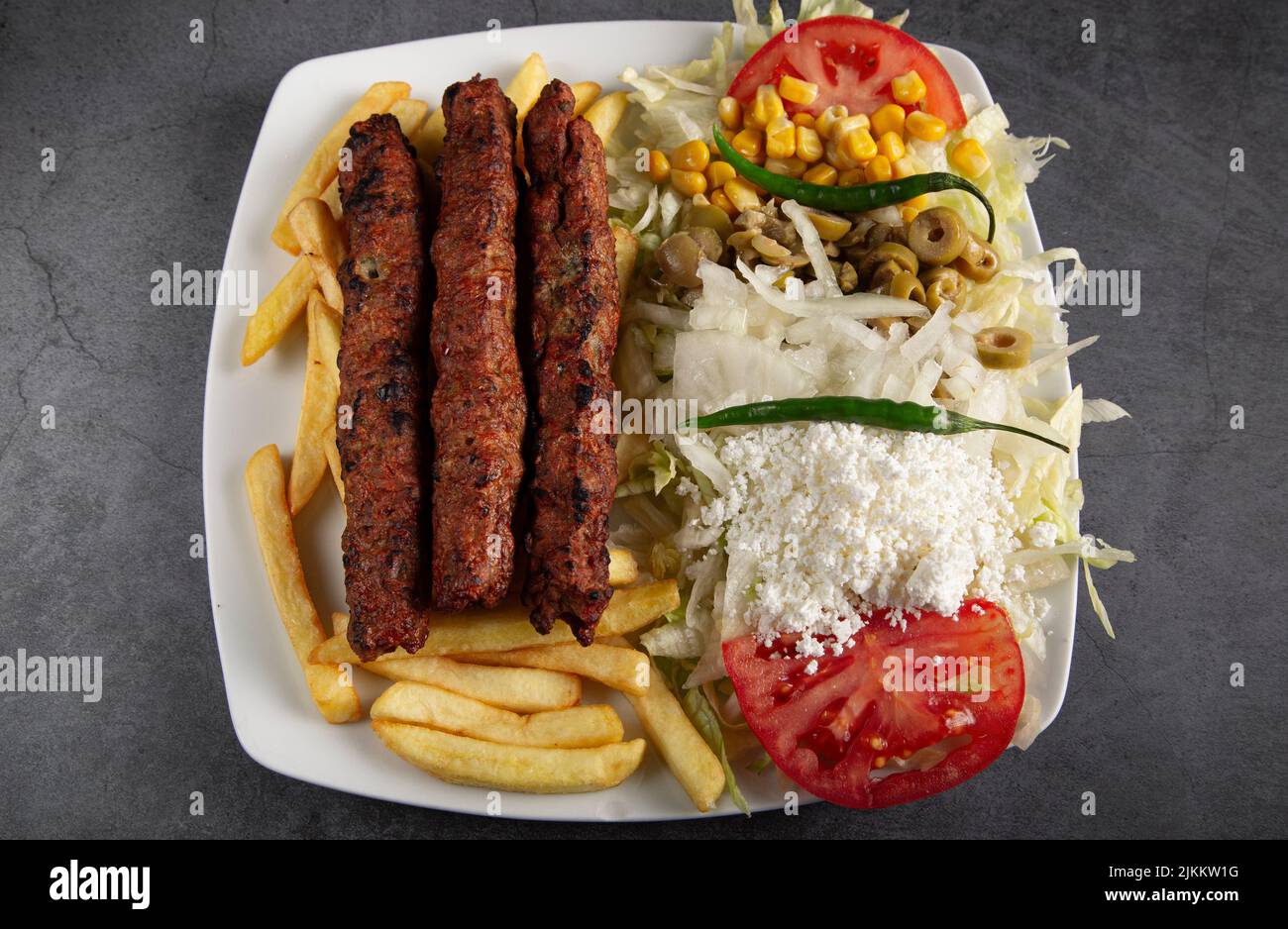 Traditional Sheek Kebab kebab dish with salad and chips Stock Photo - Alamy