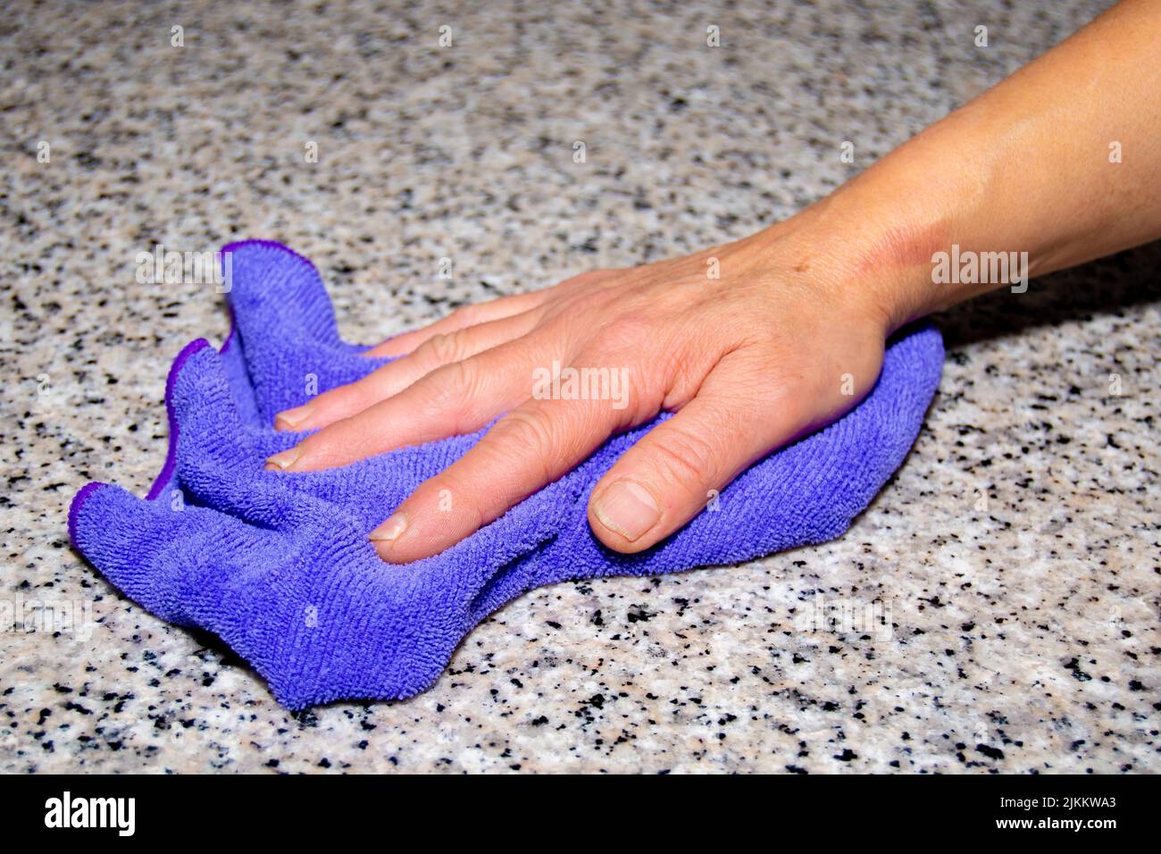 Hand cleaning a granite surface with a rag Stock Photo - Alamy Hand cleaning a granite surface with a rag Stock Photo - Alamy