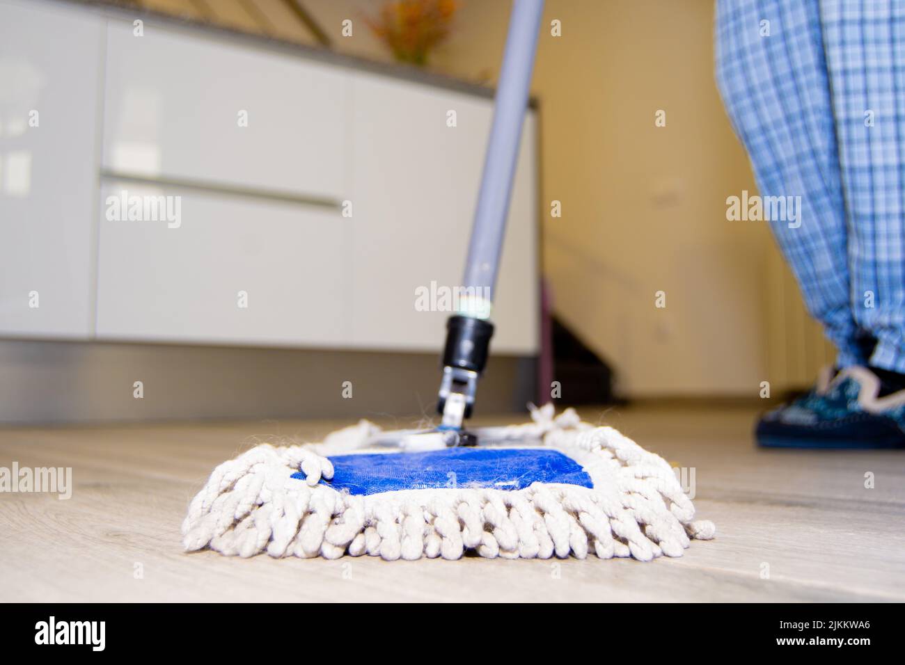 Woman cleaning the floor of a house with a mop Stock Photo - Alamy