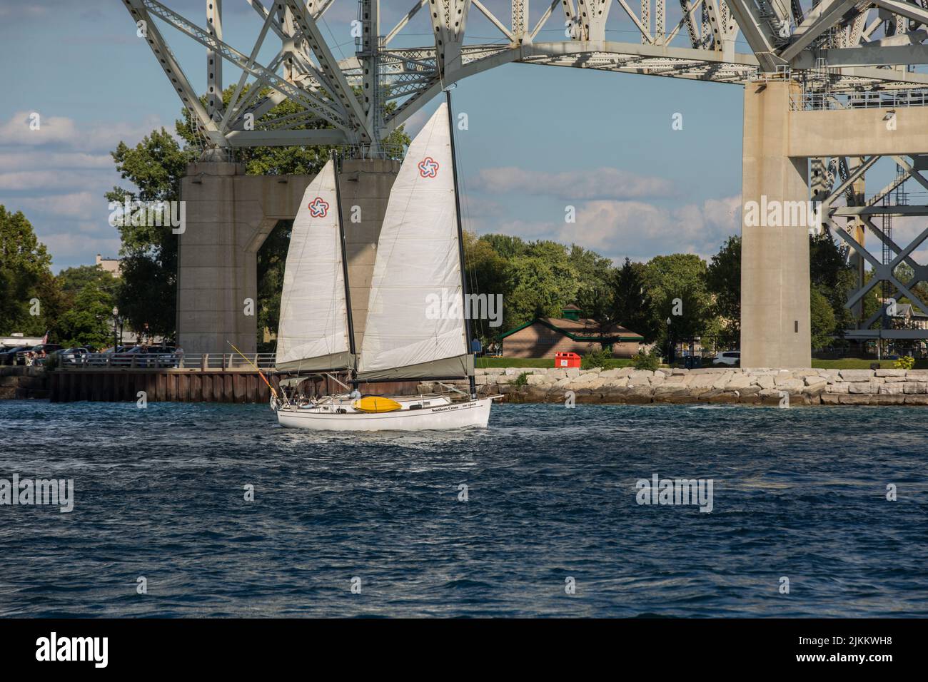 A two-mast sailboat on the St. Clair river under the Blue Water Bridge ...