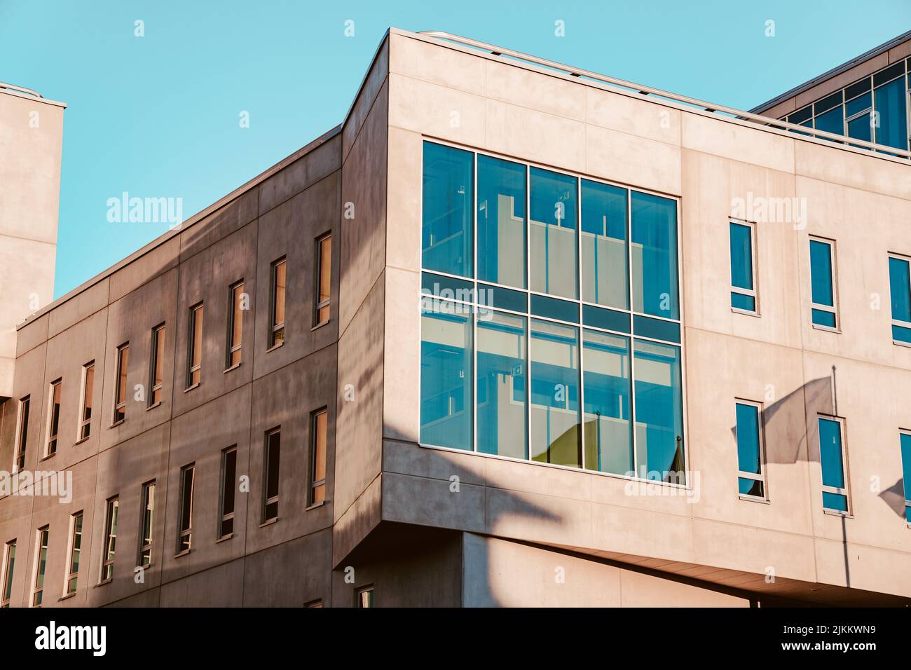 A beautiful design of a Blue glass windows on a huge minimalist ...