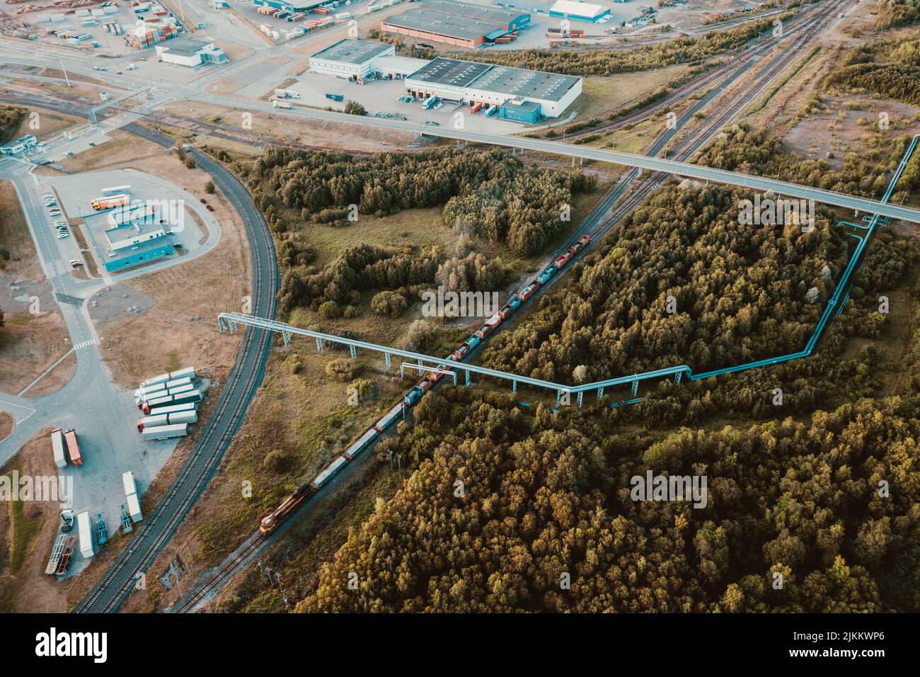 An aerial view of a freight train on a railroad in an industrial area ...
