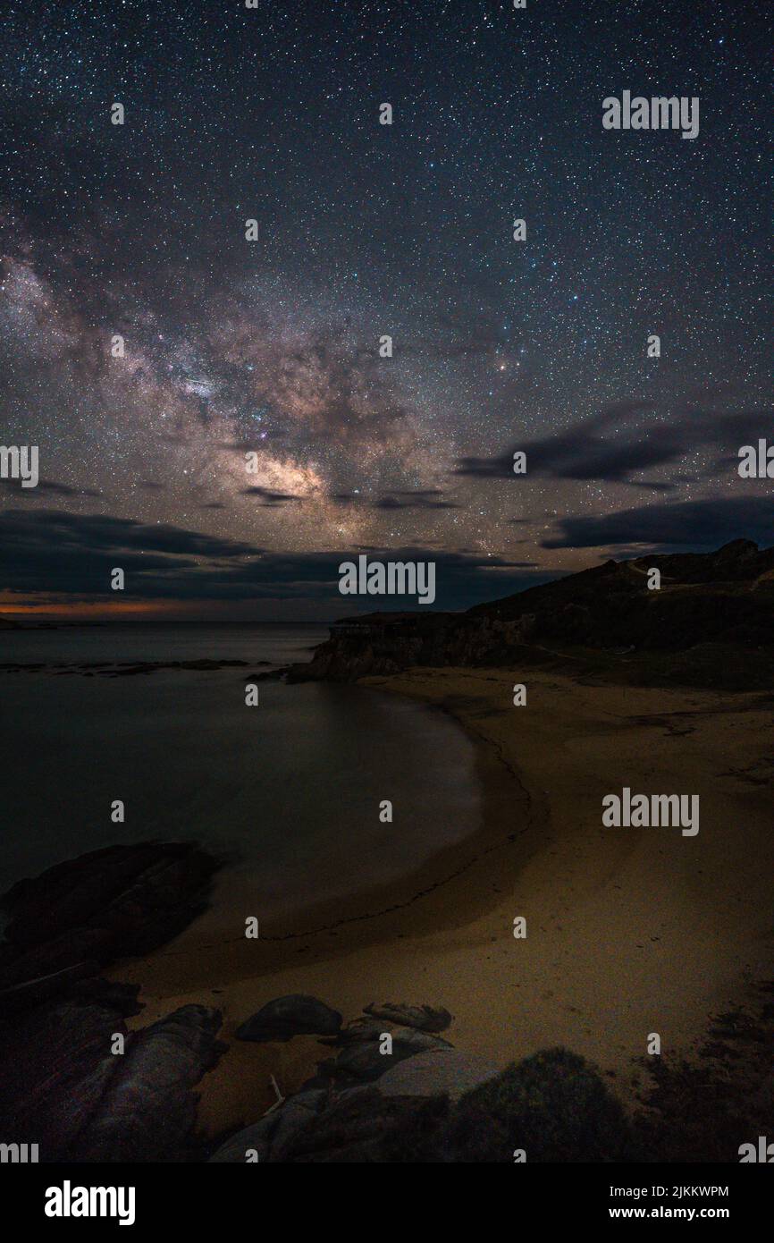 A closeup of a sea with a starry night sky Stock Photo - Alamy