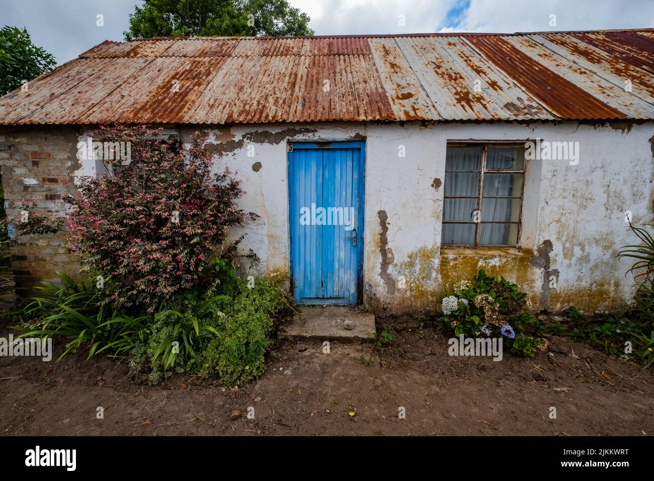 An exterior of the old house with a rusty roof Stock Photo - Alamy