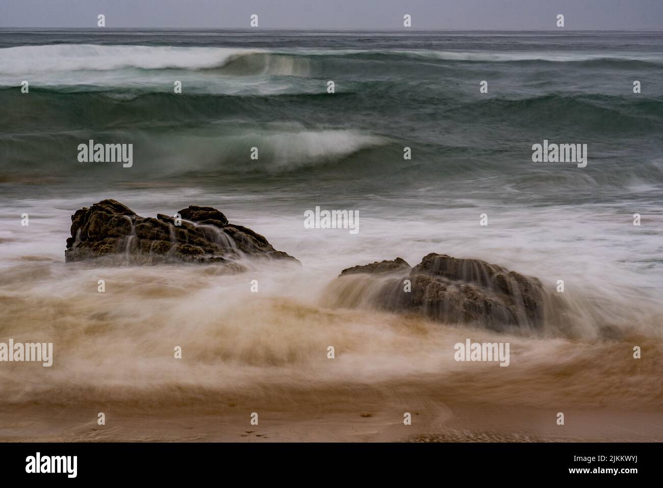 The waves crashing on the rocks near the shore Stock Photo - Alamy
