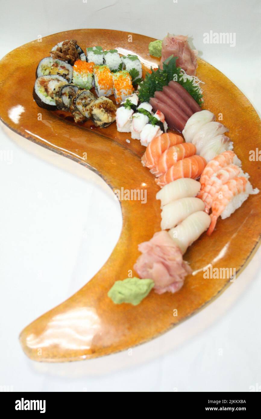 The sushi rolls in a plate on white background Stock Photo - Alamy