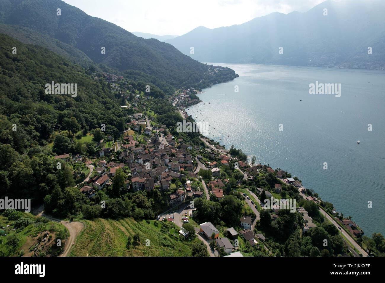 A bird's eye view of Sant Abbondio over Lago Maggiore lake and Locarno mountains in Ticino ...