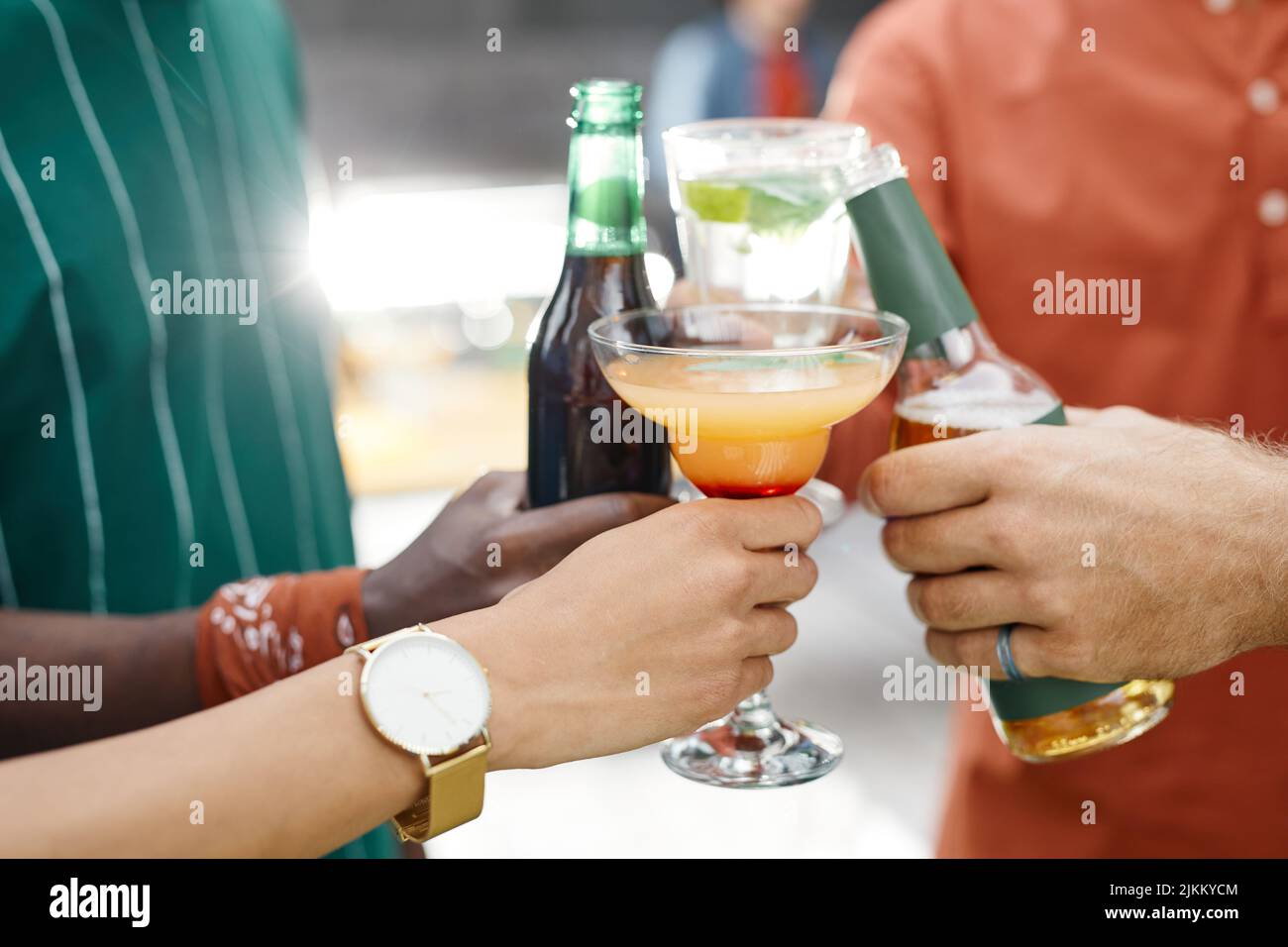 Two people clinking cocktail glasses hi-res stock photography and ...