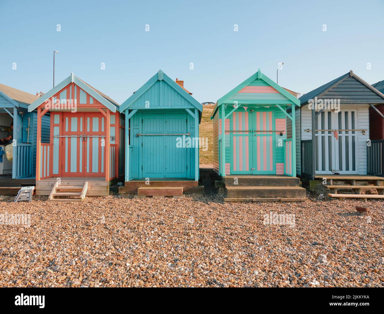 The colourful painted wooden beach huts on Herne Bay beach, North Kent ...