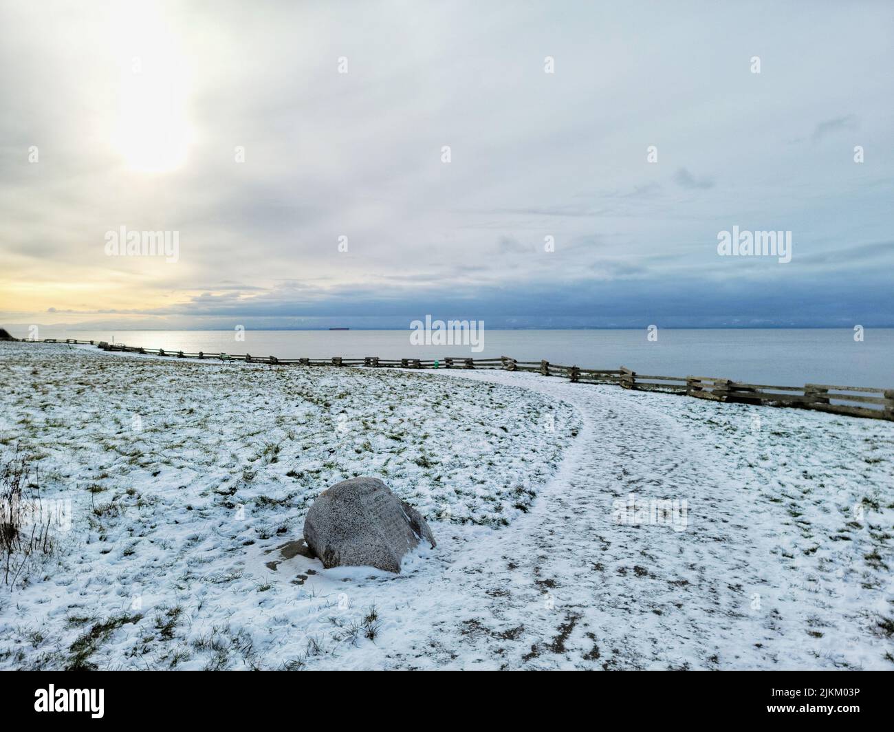 A tranquil scenery of the Dallas Road covered in snow and ocean in the ...
